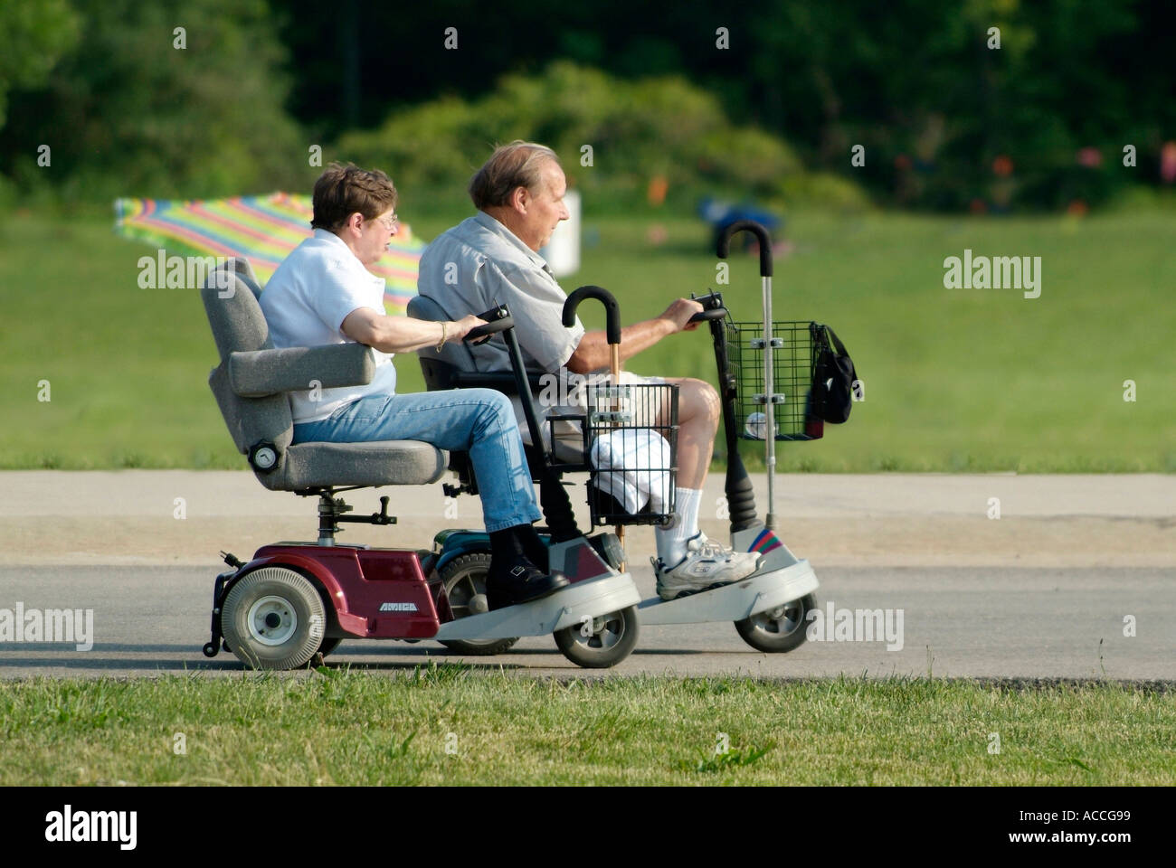 Handicapped adults ride in a battery powered wheelchair while attending ...