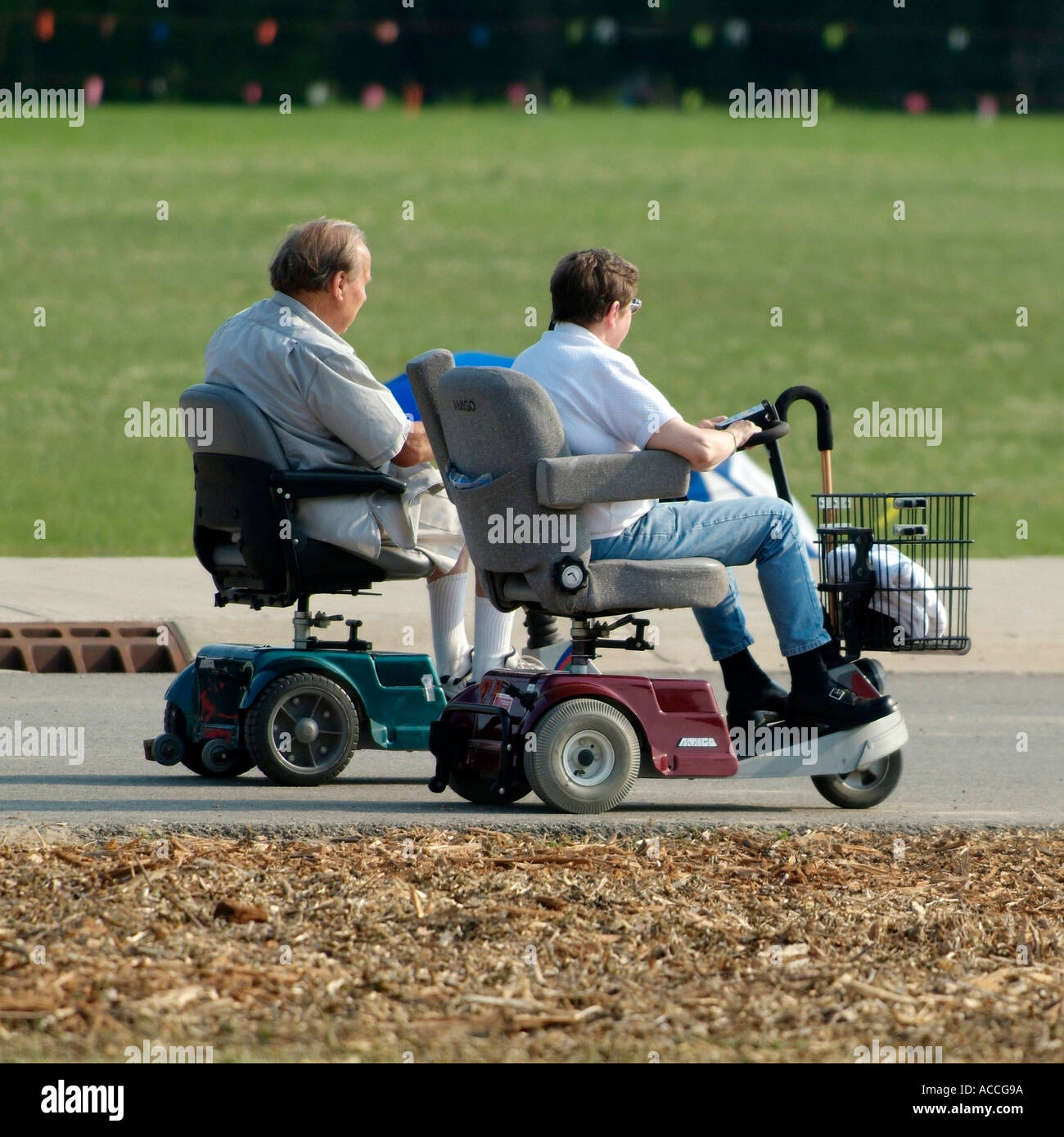 Handicapped adults ride in a battery powered wheelchair while attending ...
