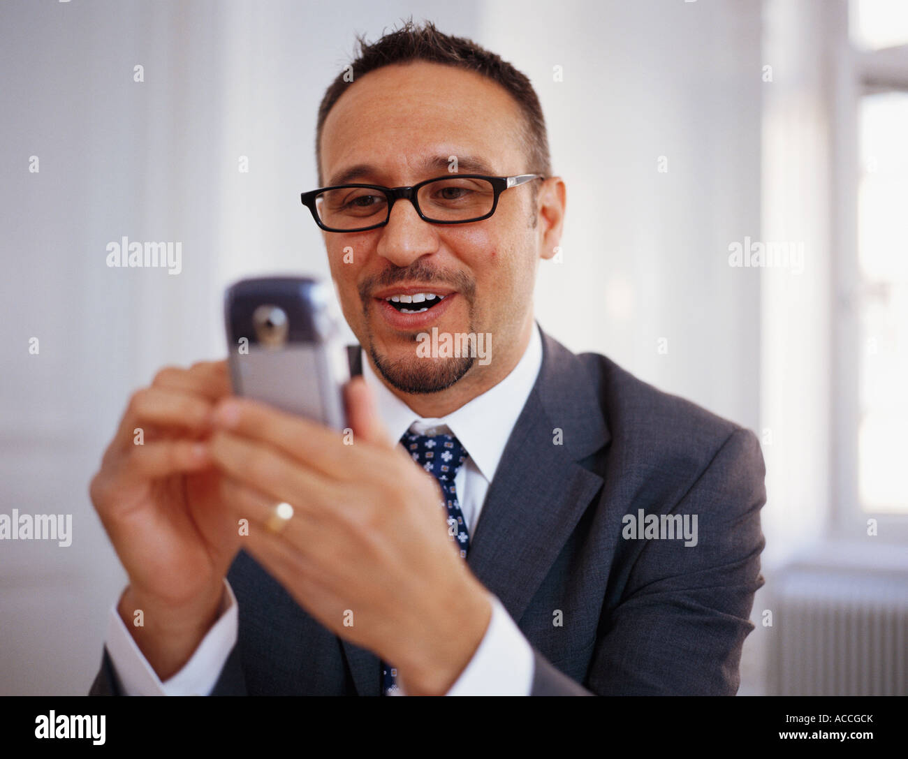 A smiling man with a mobile phone Stock Photo - Alamy
