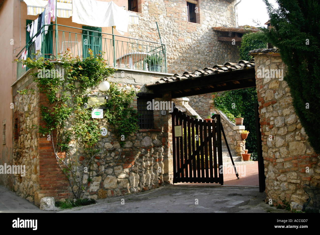 Driveway with gate open Italy Stock Photo - Alamy