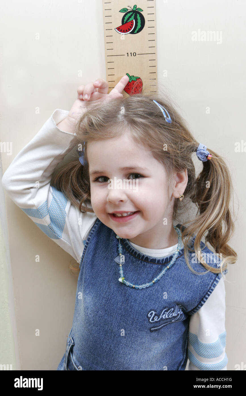 A little girl is measuring its height Stock Photo - Alamy