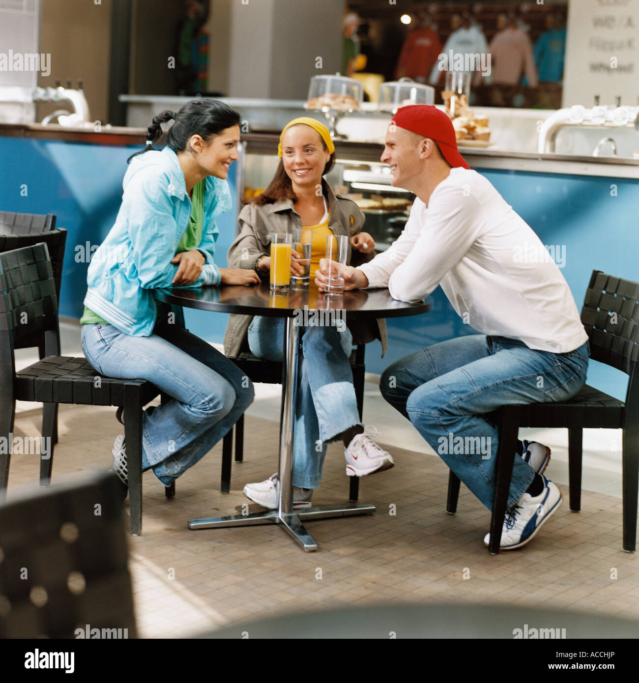 Three people at a café Stock Photo - Alamy
