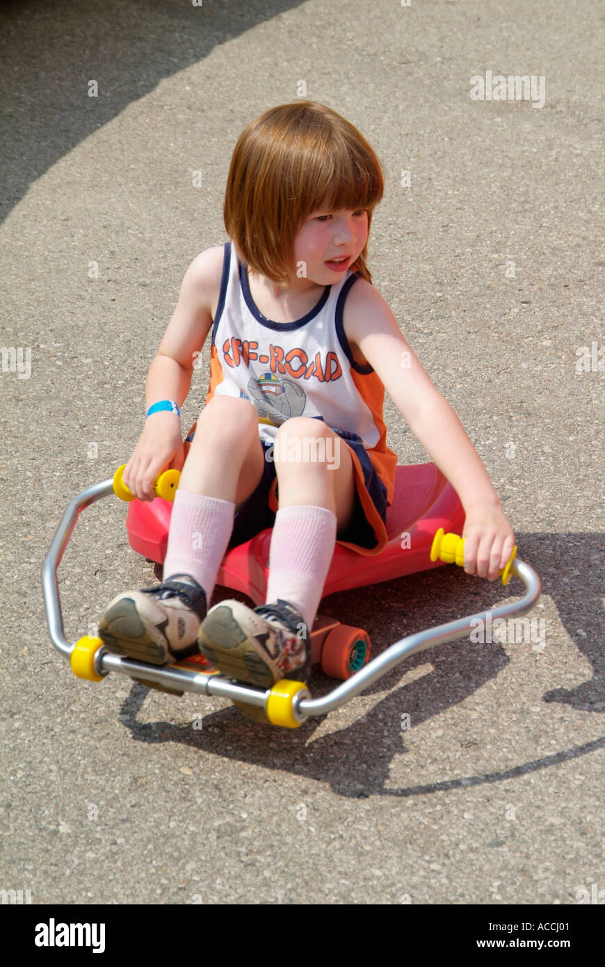 Girl toddler rides on safe roller vehicle platform Stock Photo - Alamy