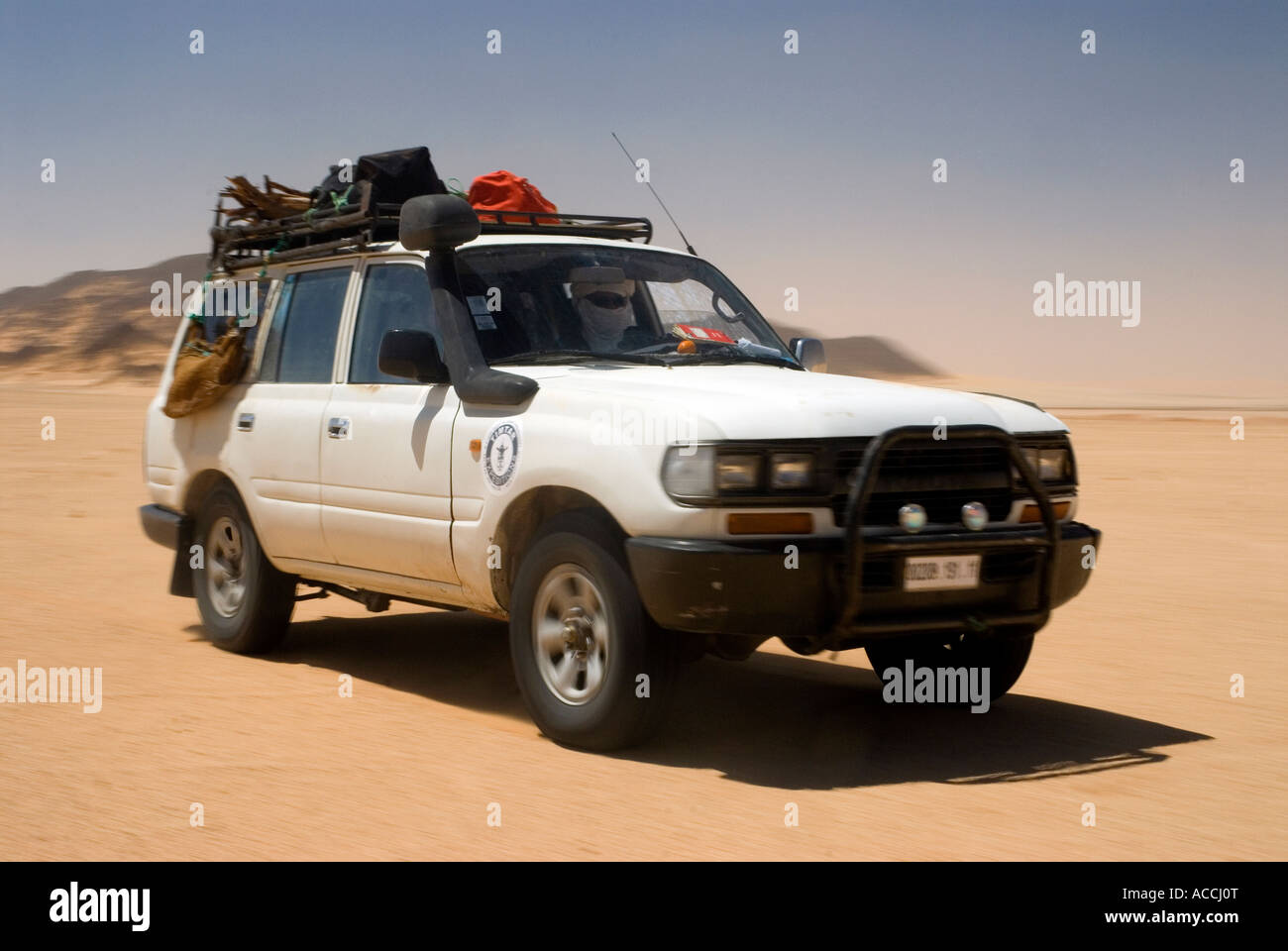 A Tuareg Landcruiser crosses the awesome Tassili N'Ajjer landscape in ...