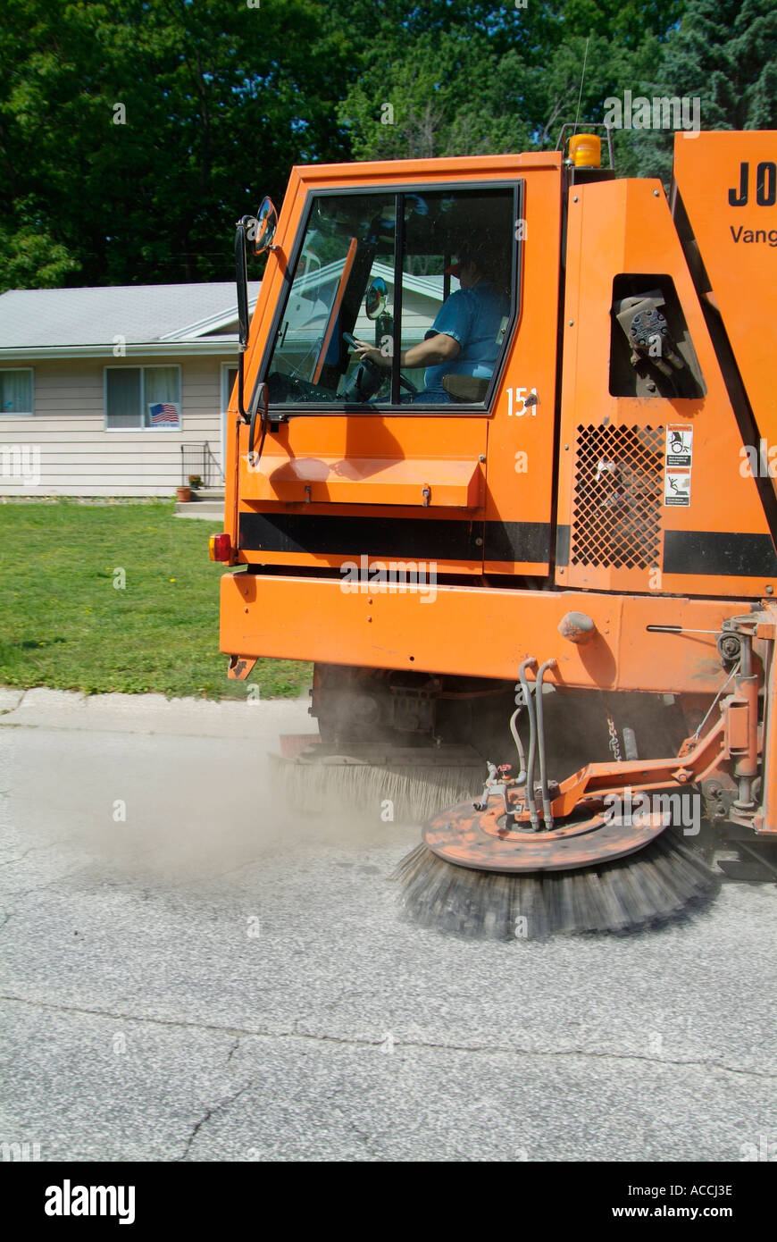 Street sweeper cleans city streets Stock Photo - Alamy