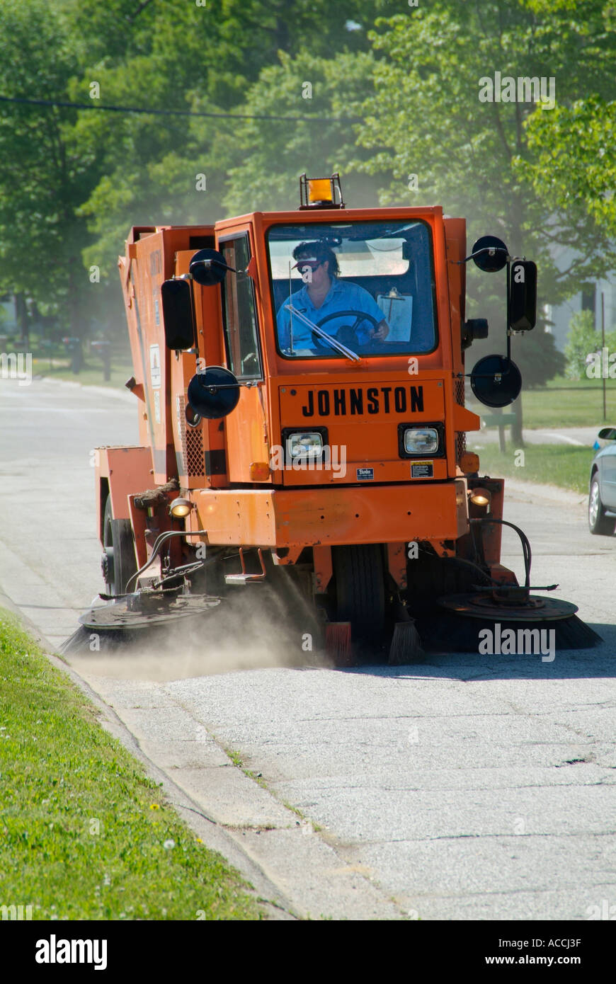 Street sweeper cleans city streets Stock Photo - Alamy