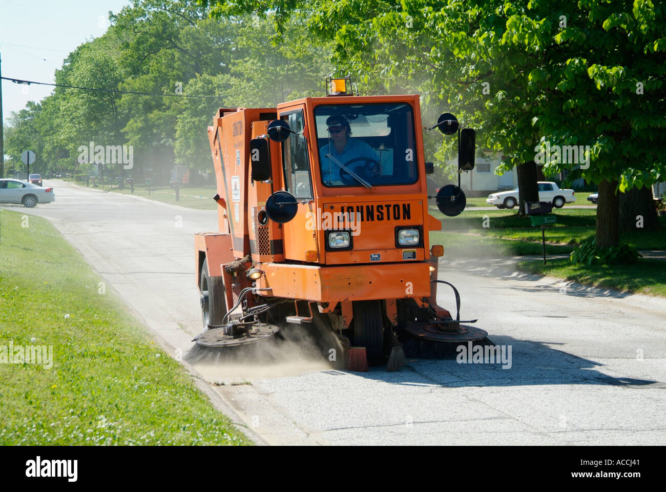 Street sweeper cleans city streets Stock Photo - Alamy