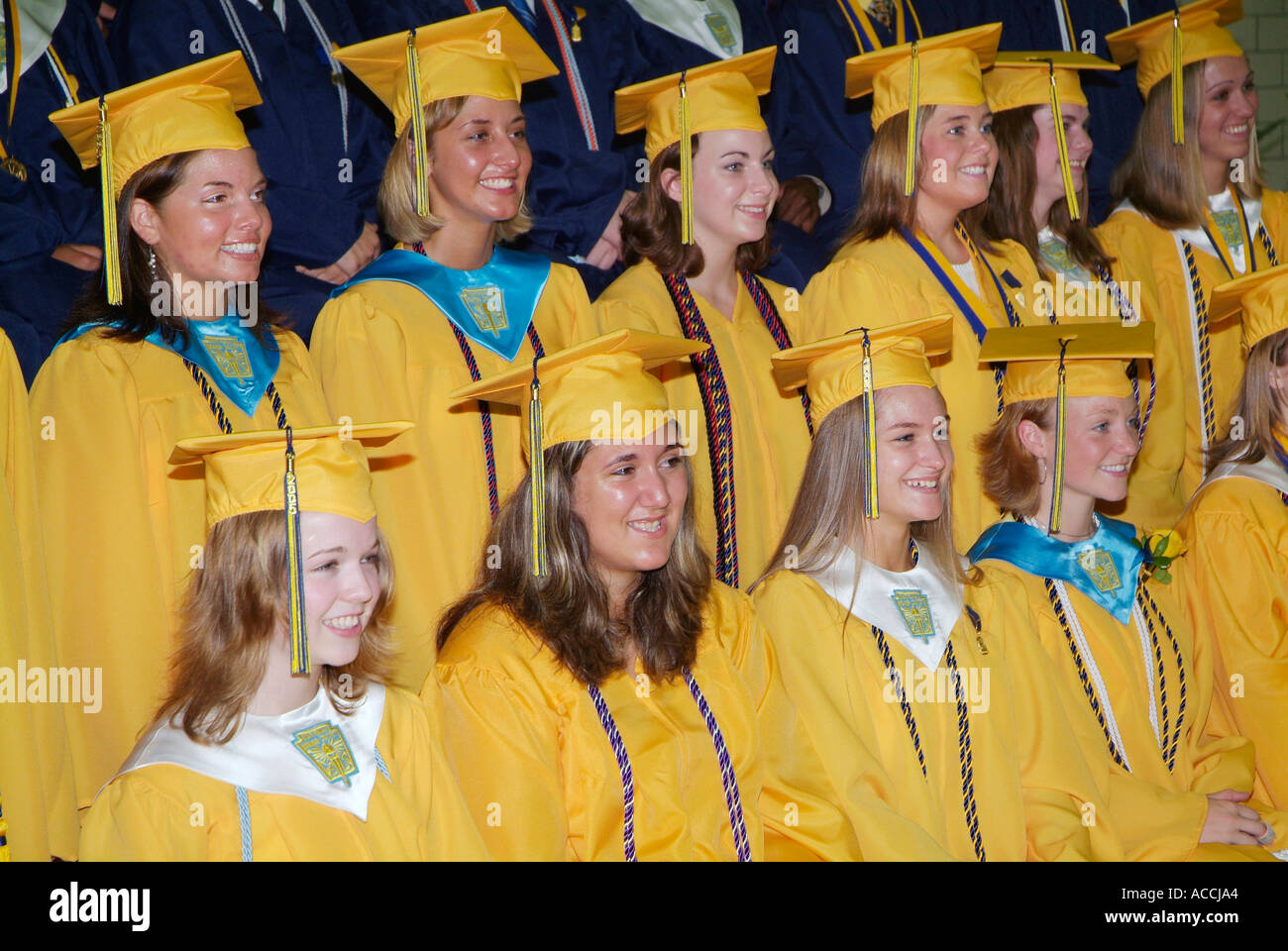 High School students sit in their caps and gowns during graduation ...