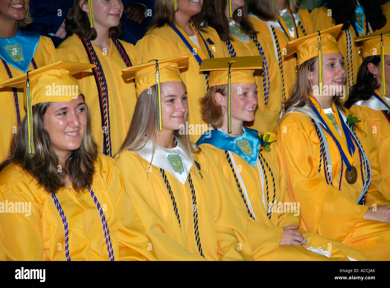 High School students sit in their caps and gowns during graduation ...
