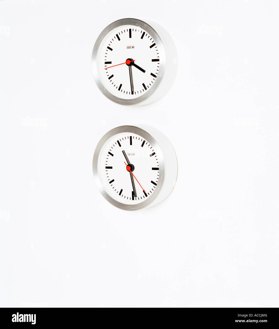 Two clocks on a white background Stock Photo - Alamy
