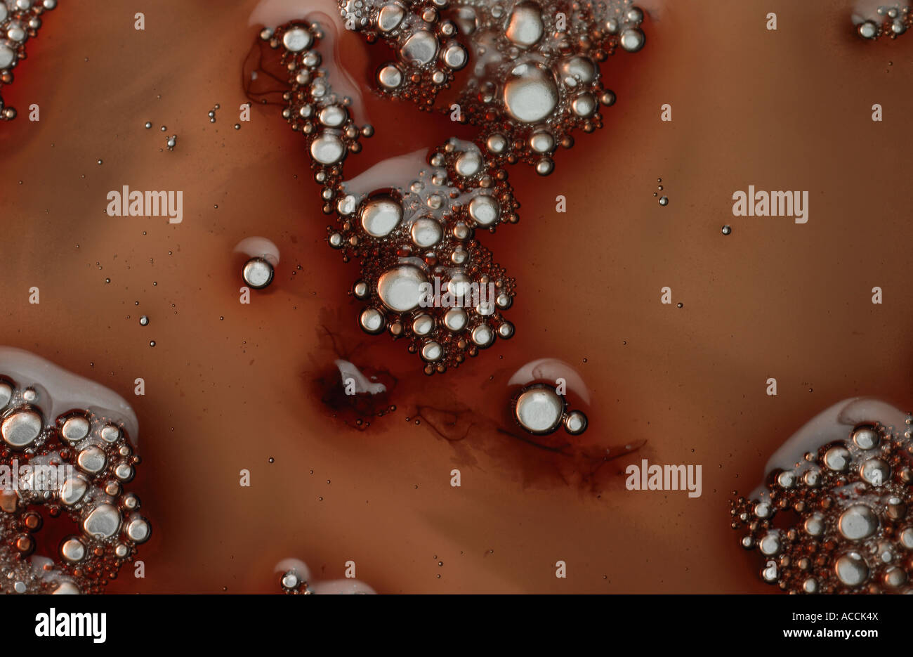 Bubbles in brown fluid Stock Photo - Alamy