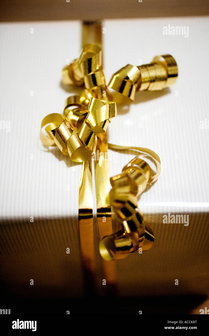 A parcel with a golden string close-up Stock Photo - Alamy