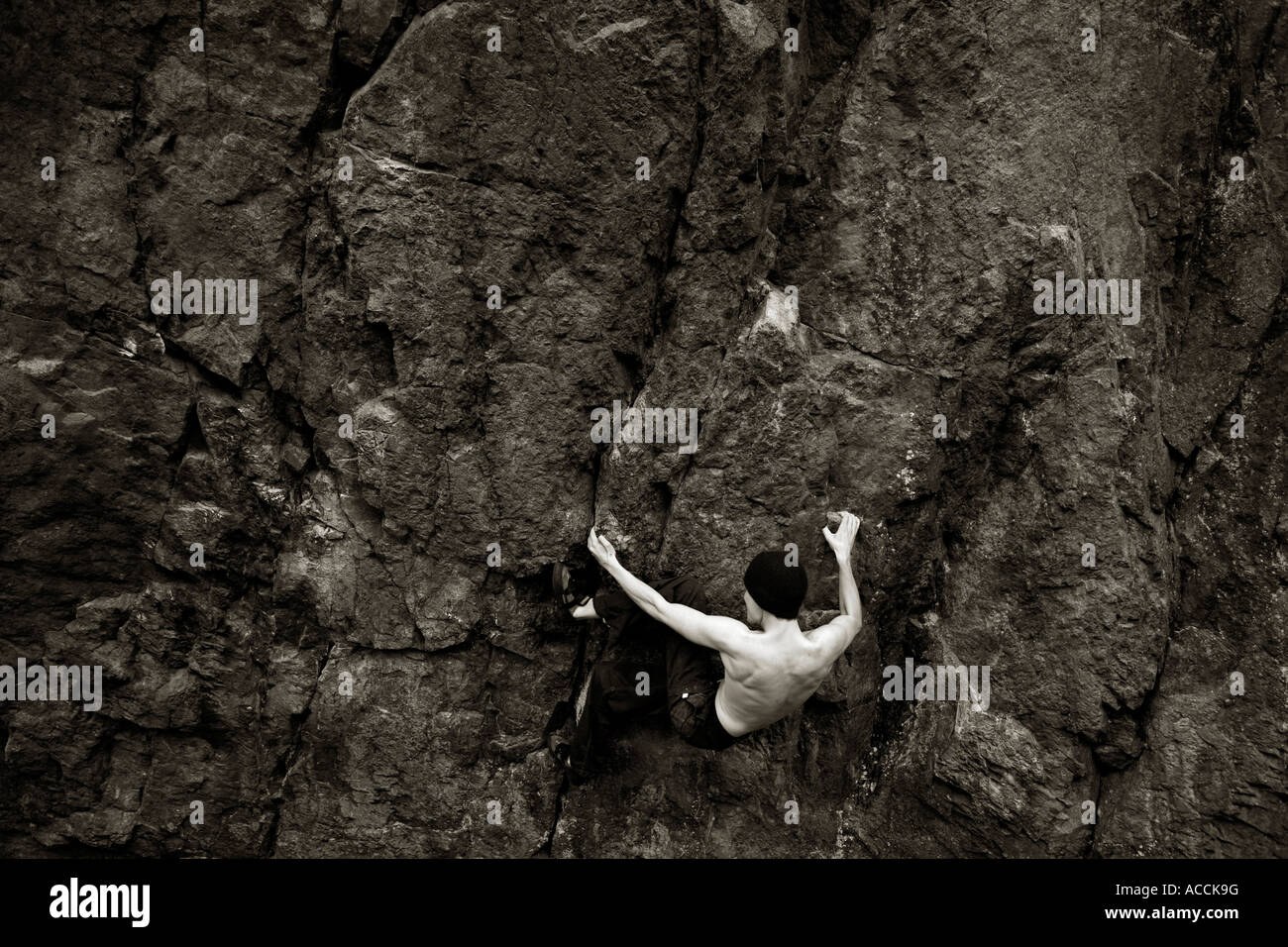 A man climbing a cliff face BW Stock Photo - Alamy