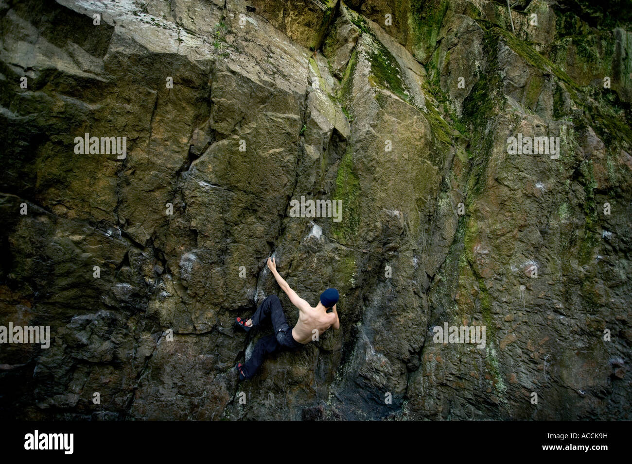 A man climbing a cliff face Stock Photo - Alamy