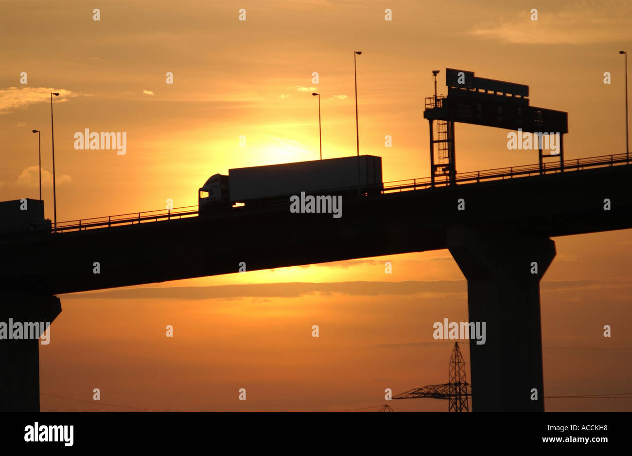 a lorry crossing the dartford bridge with the sunset in the background ...