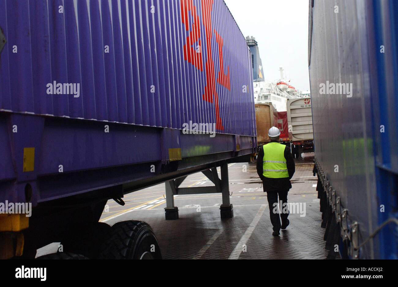 a customs officer checking out lorries Stock Photo - Alamy