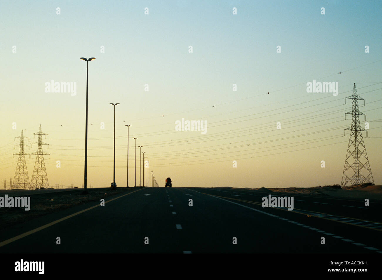 Road with power-line poles in the background Stock Photo - Alamy