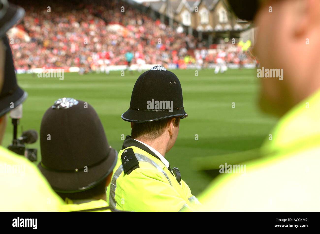police officers at a football match watching the crowds of football ...