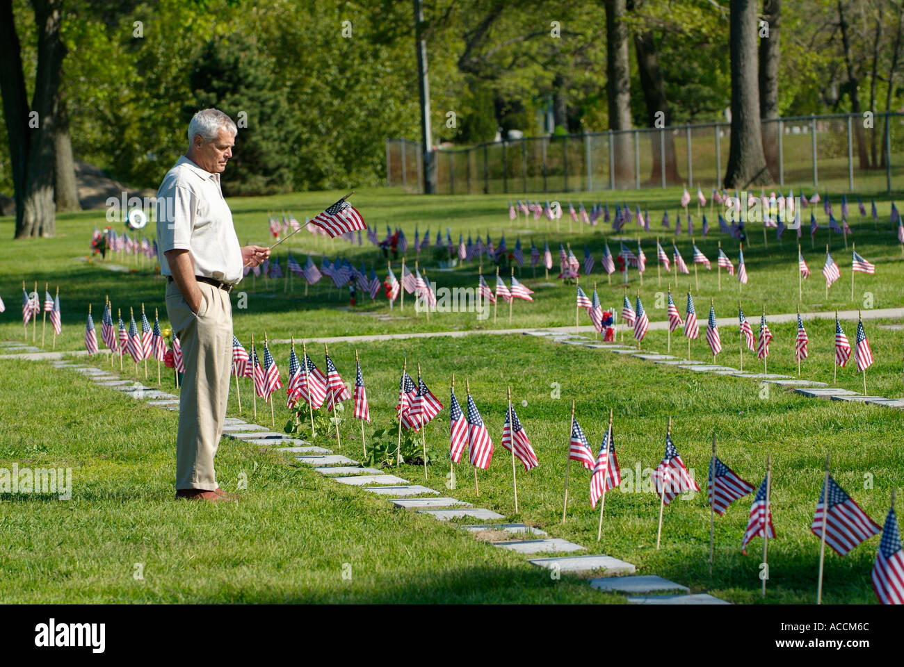 Family visits cemetery on Memorial Day to place flags on graves Stock ...