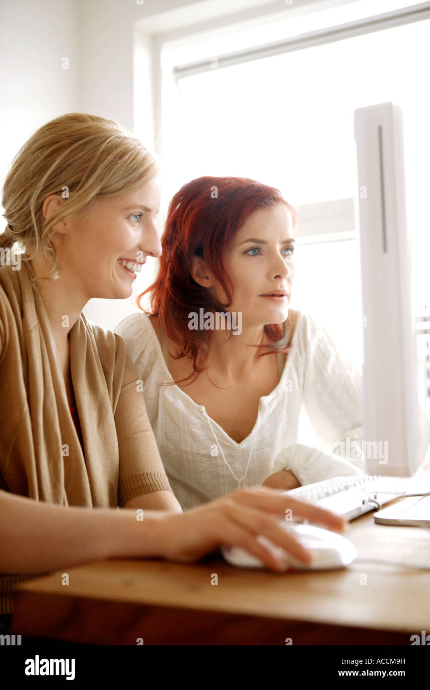 Two women by a computer Stock Photo - Alamy