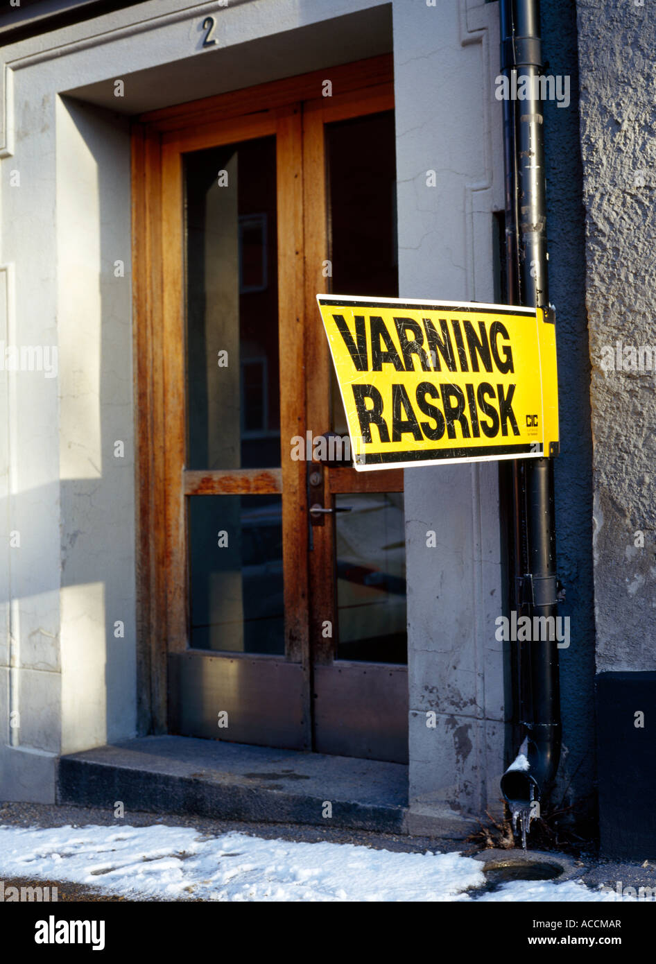 A warning sign in front of an apartment house Stock Photo - Alamy