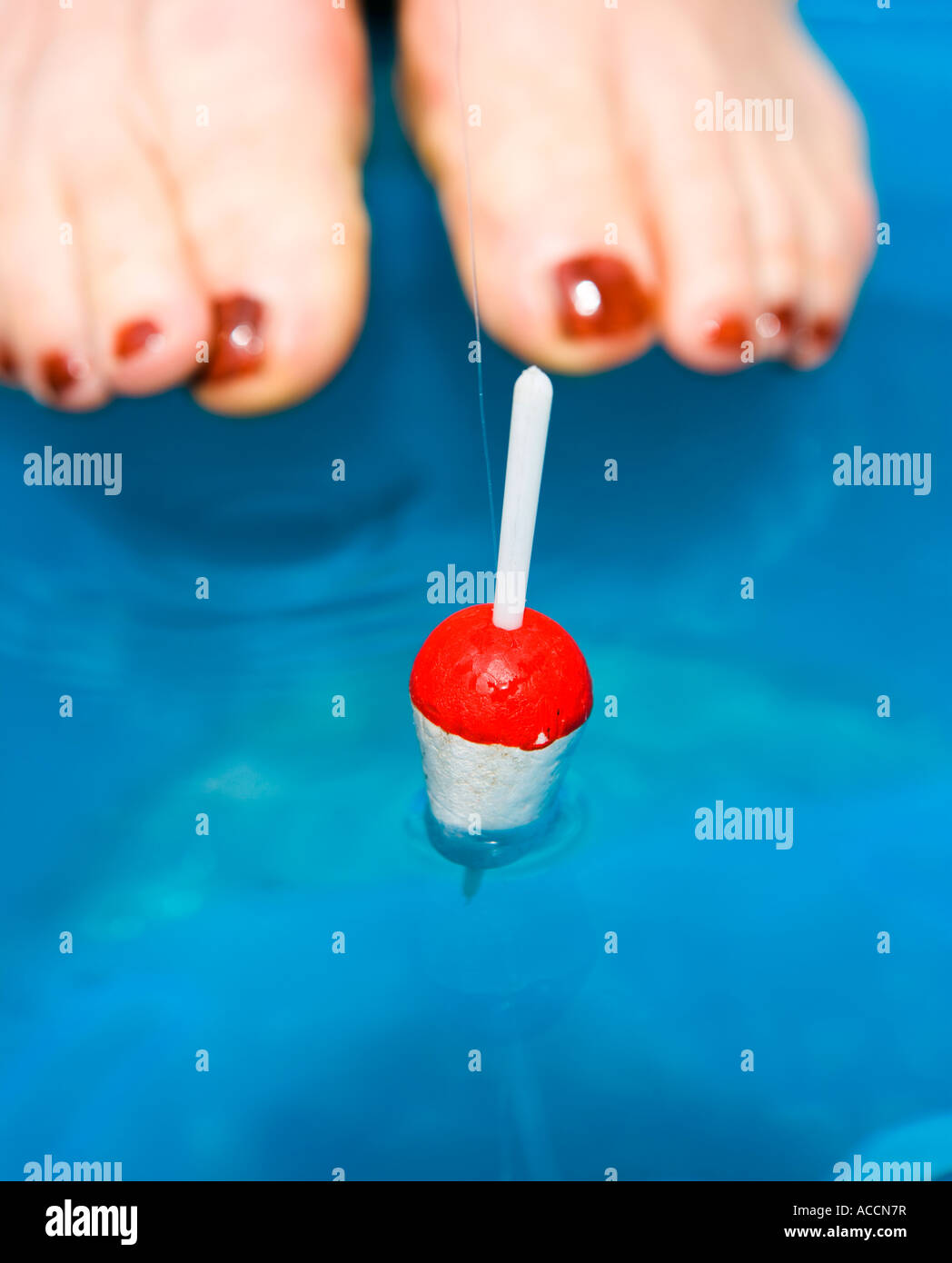 Float in the water with feet in the background Stock Photo - Alamy