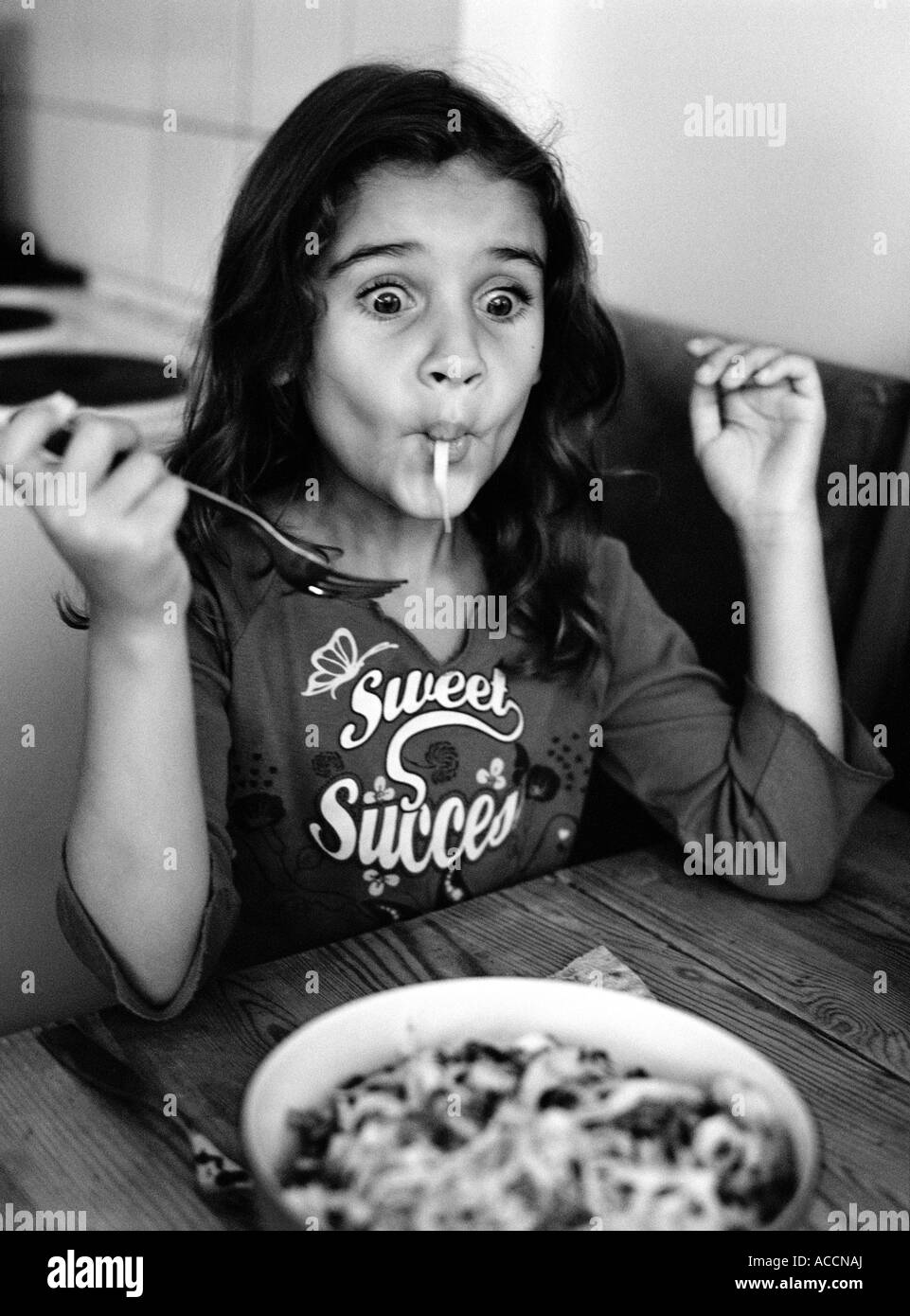 Girl eating spaghetti Stock Photo - Alamy