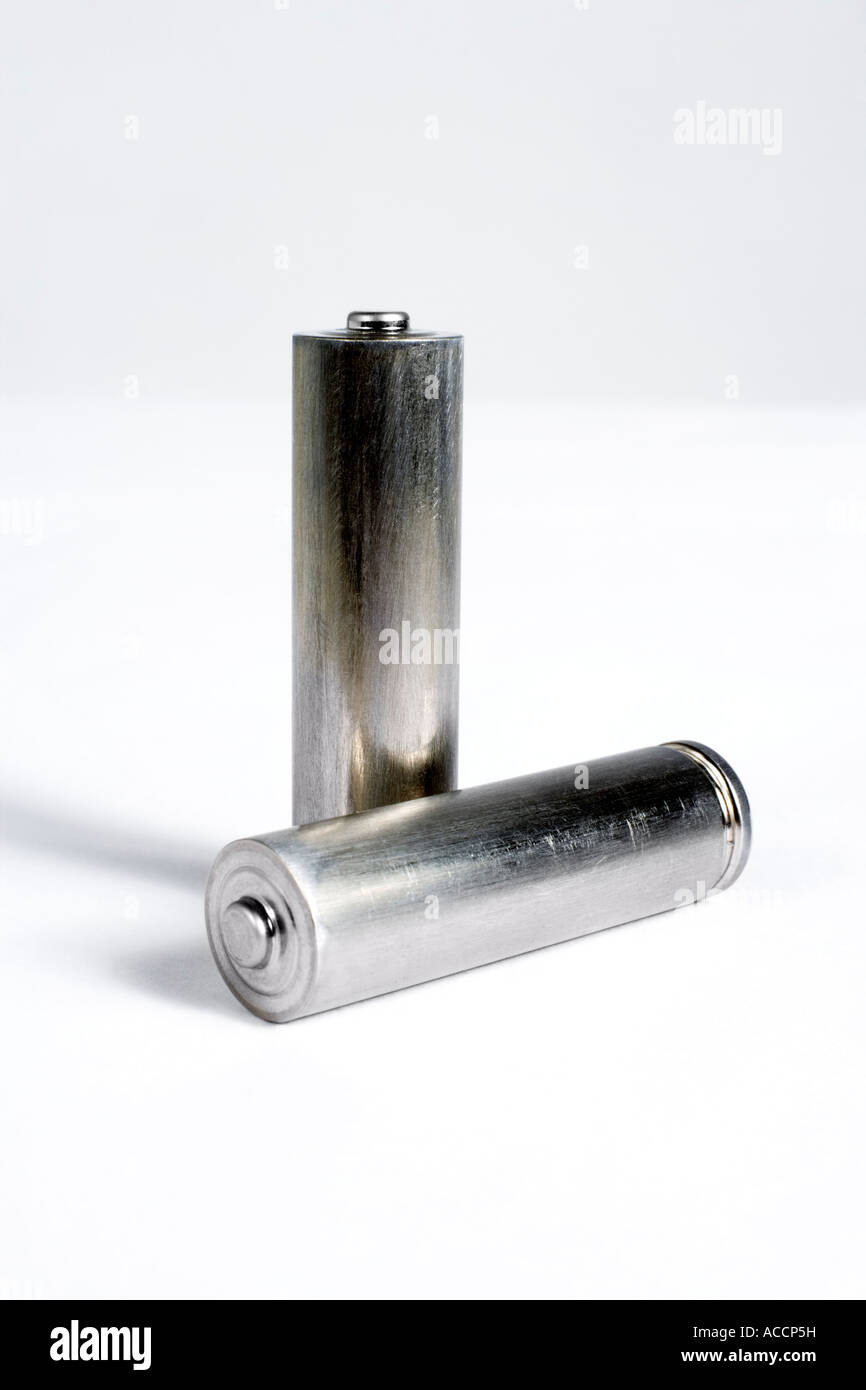 Two batteries on a white background Stock Photo - Alamy