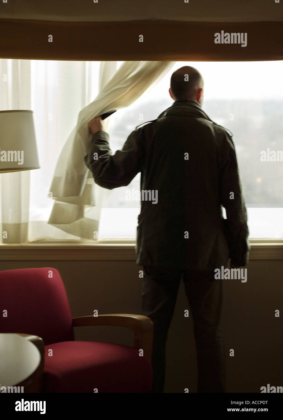 A man looking out a window Stock Photo - Alamy