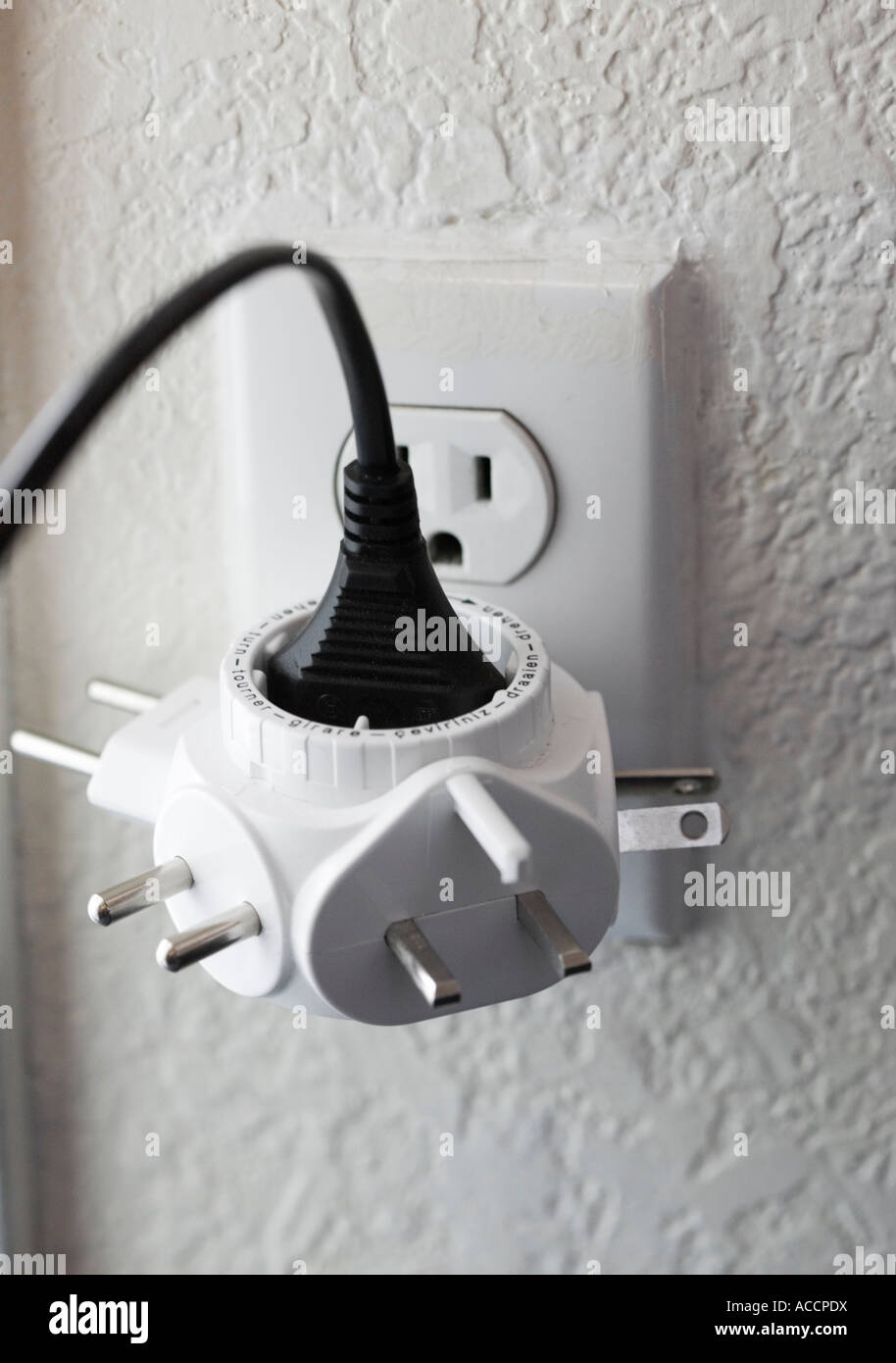 A multi adapter in a socket Stock Photo - Alamy