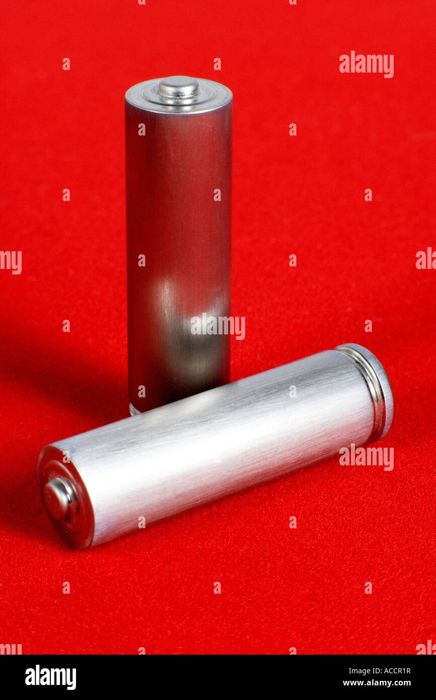 Batteries on a red background Stock Photo - Alamy