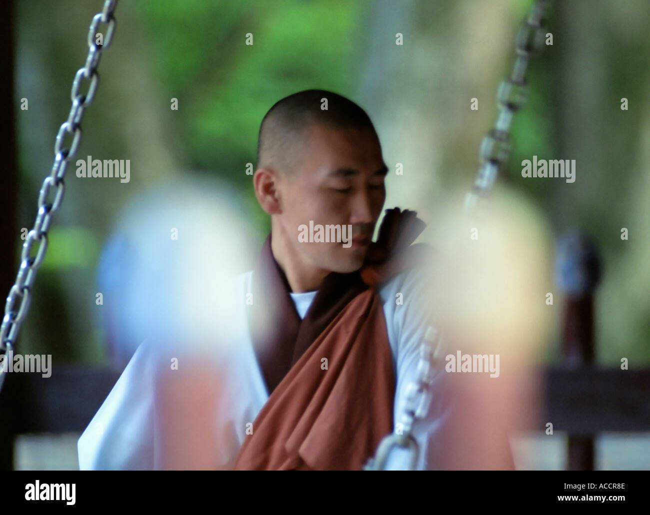Monk ringing the giant bell at Tongdosa one of the largest and most ...