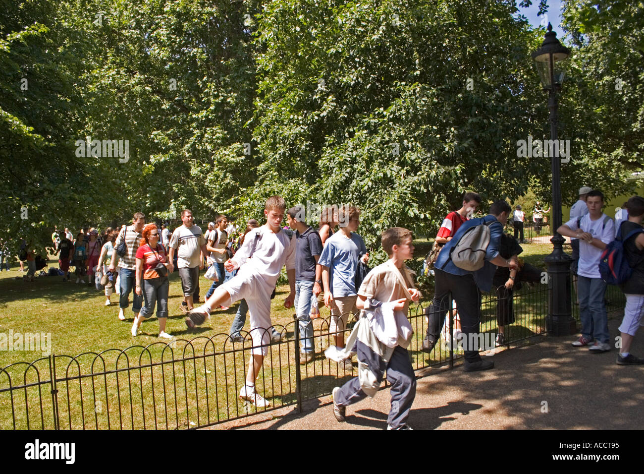 a crowd of people walking over a fence during evacuation Stock Photo ...
