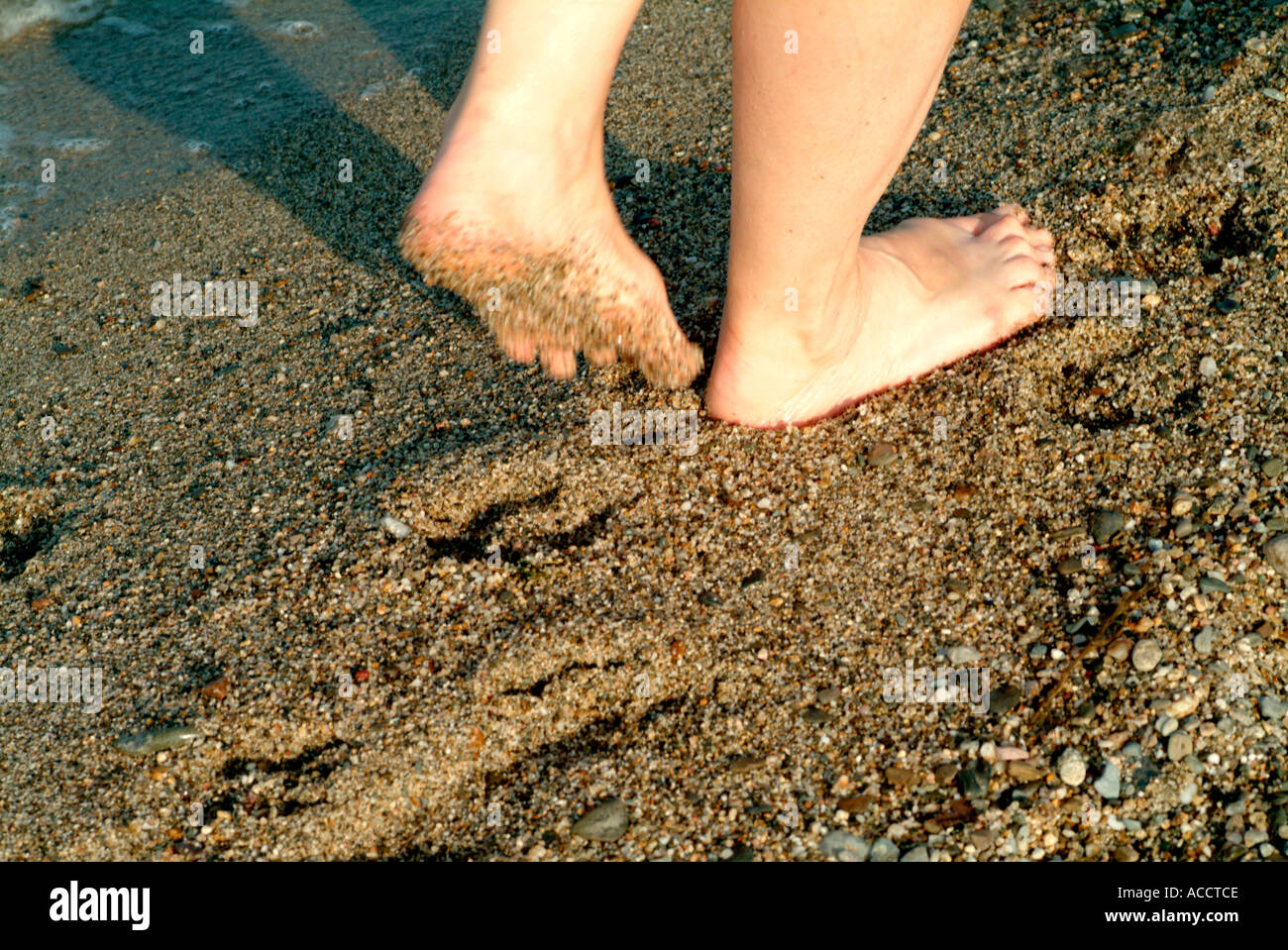 MR feet walking bare footed on a beach Stock Photo - Alamy