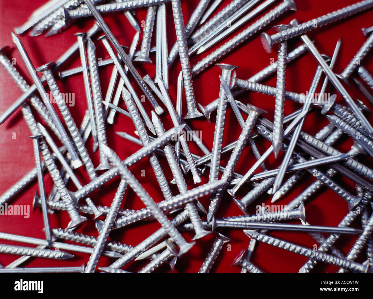 Nails on a red background Stock Photo - Alamy