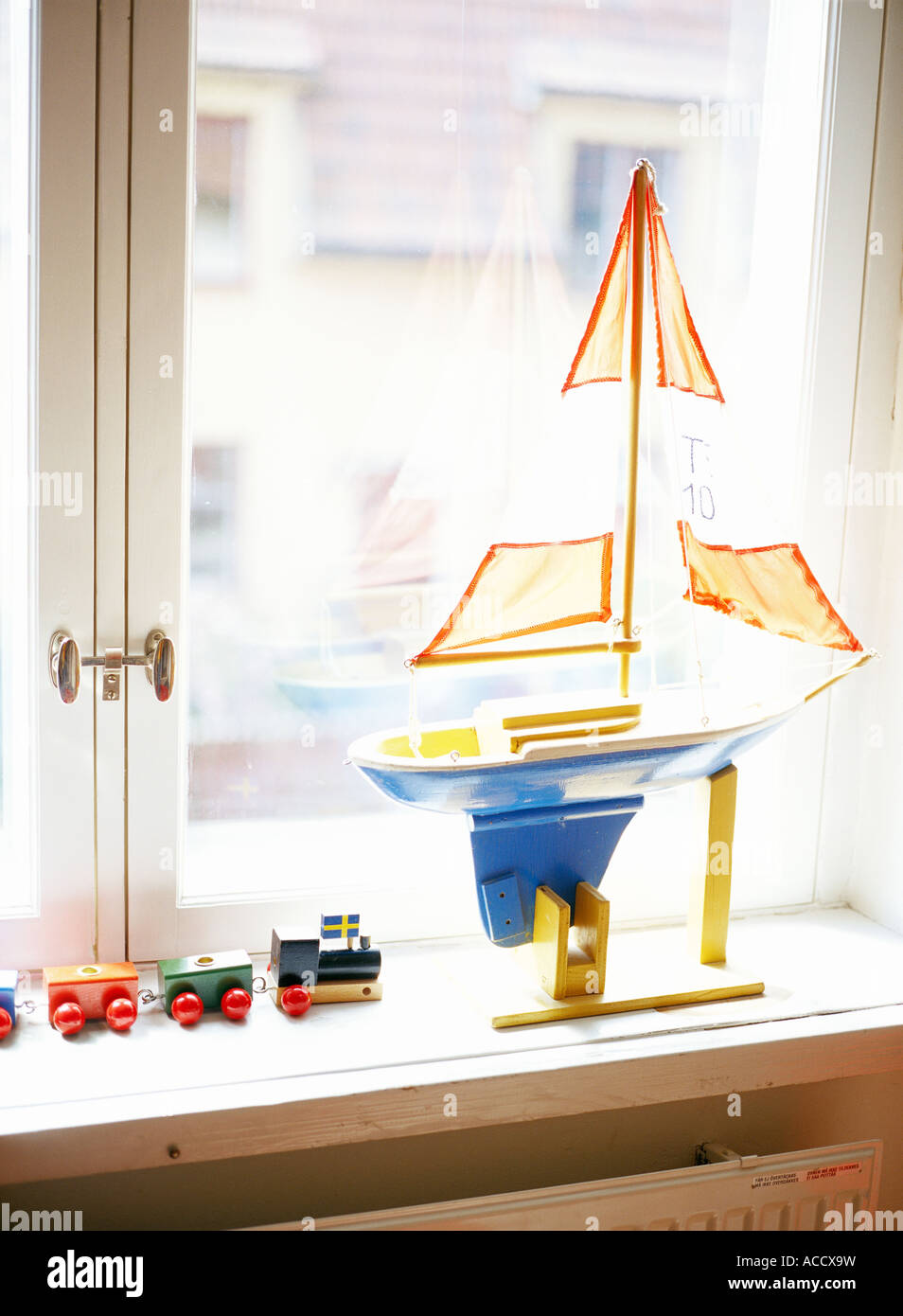 A toy boat and a toy train in a window Stock Photo - Alamy