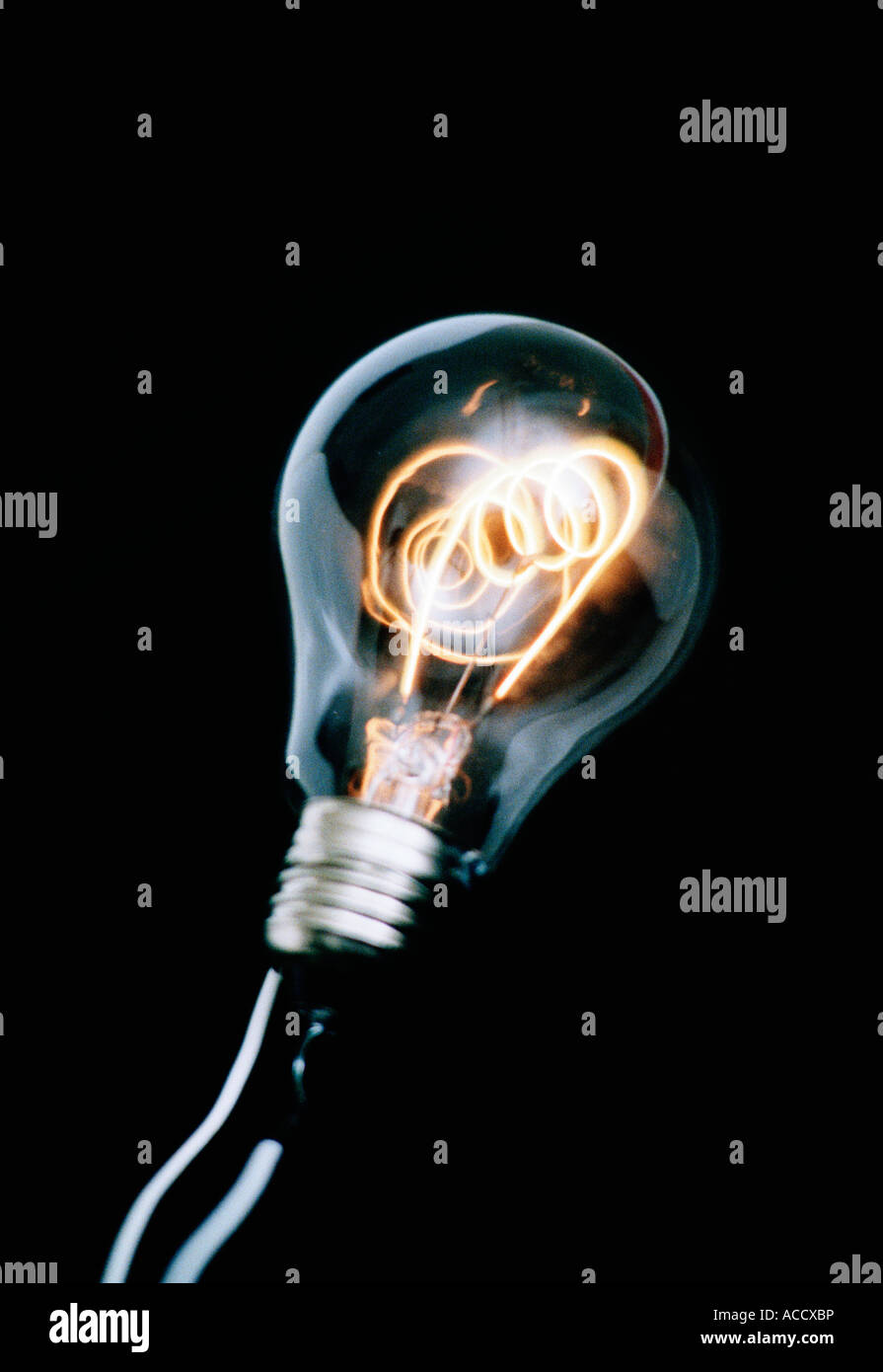 A light bulb on a black background Stock Photo - Alamy