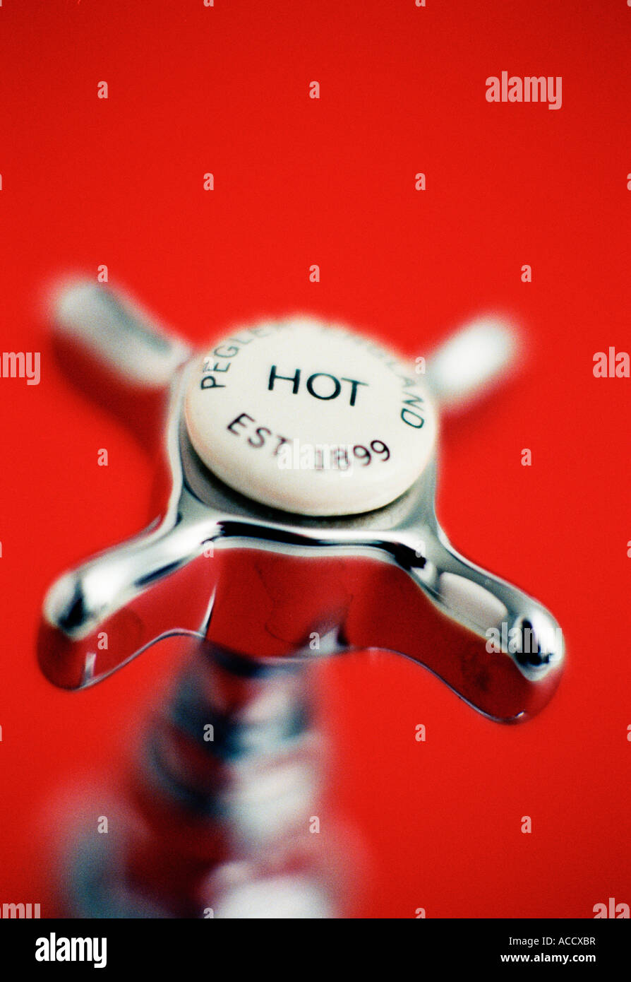 A hot water tap on a red background Stock Photo - Alamy