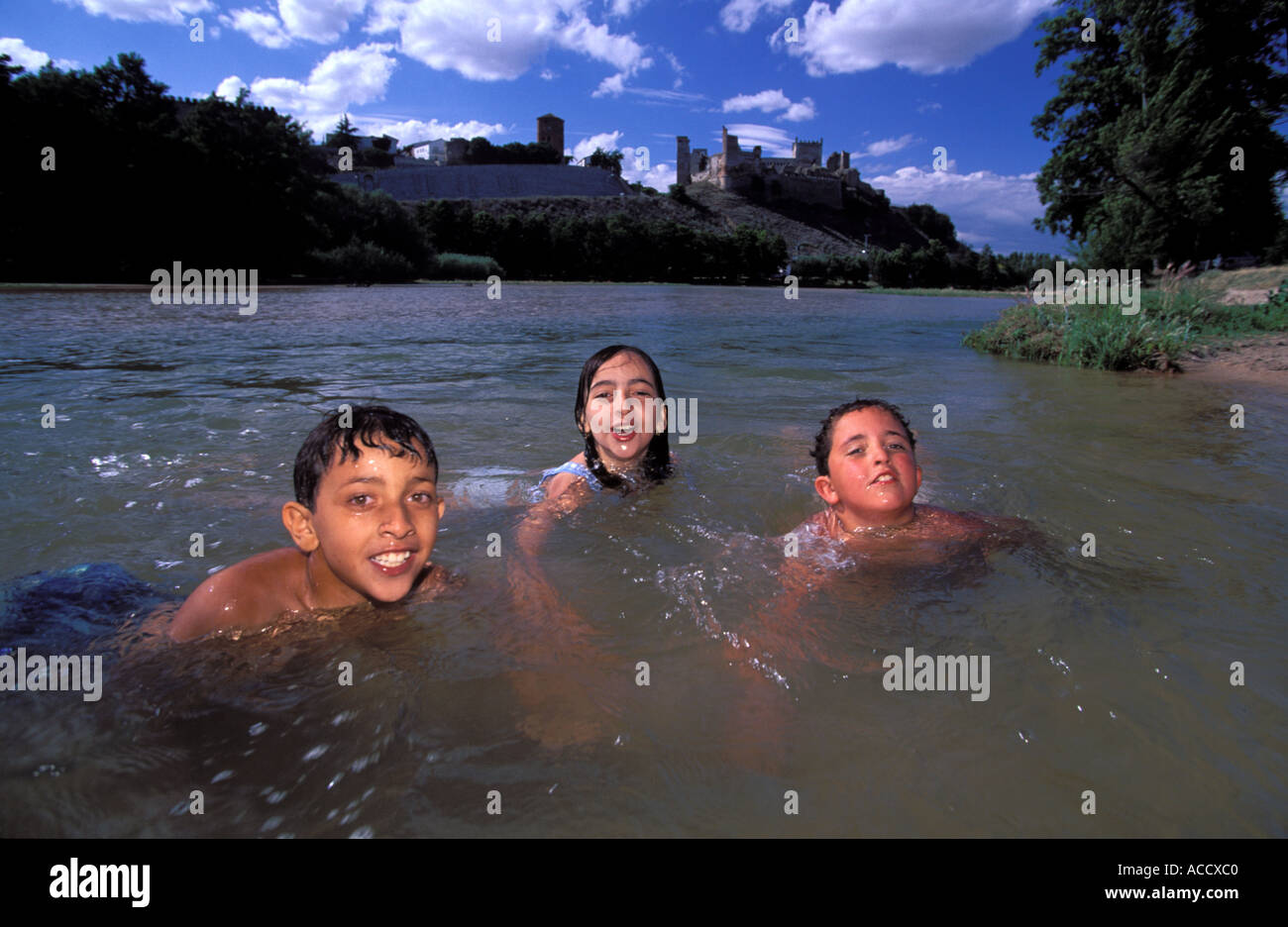 children swimming in river castle of escalona Stock Photo - Alamy