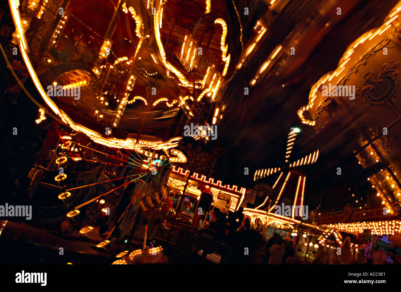 lighted merry go round and gaudy lights on fair fairground amusement ...