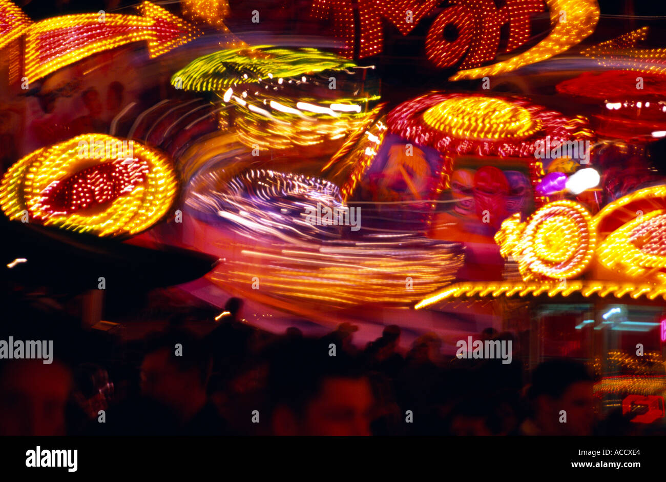 lighted merry go round and gaudy lights on fair fairground amusement ...