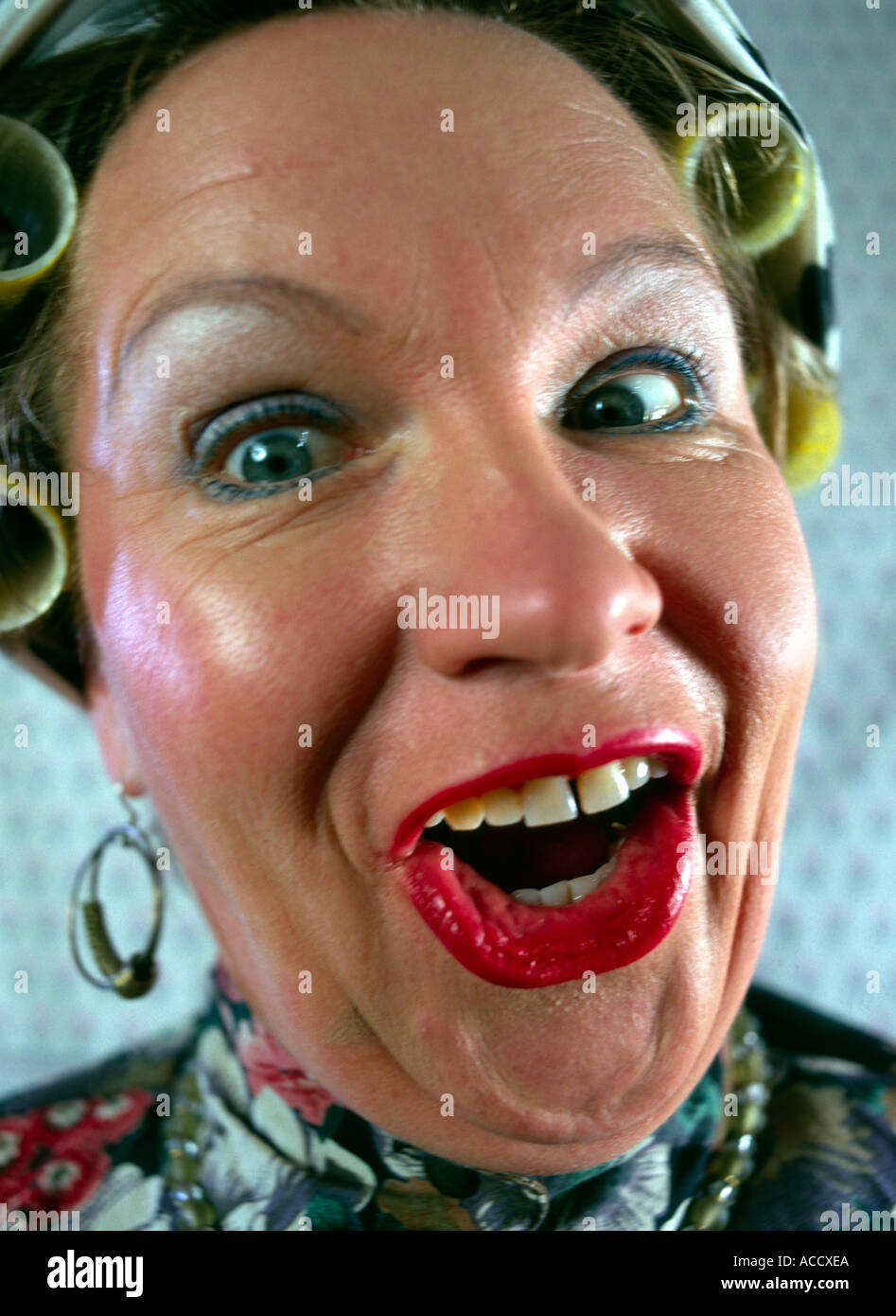 MR woman with curlers making a grimace Stock Photo - Alamy
