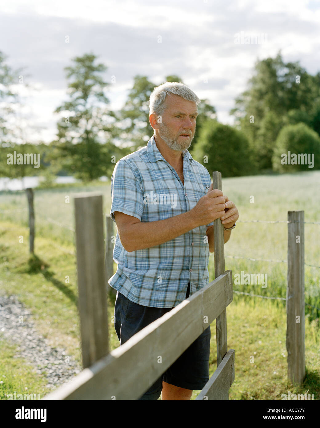 A man by a gate Stock Photo - Alamy
