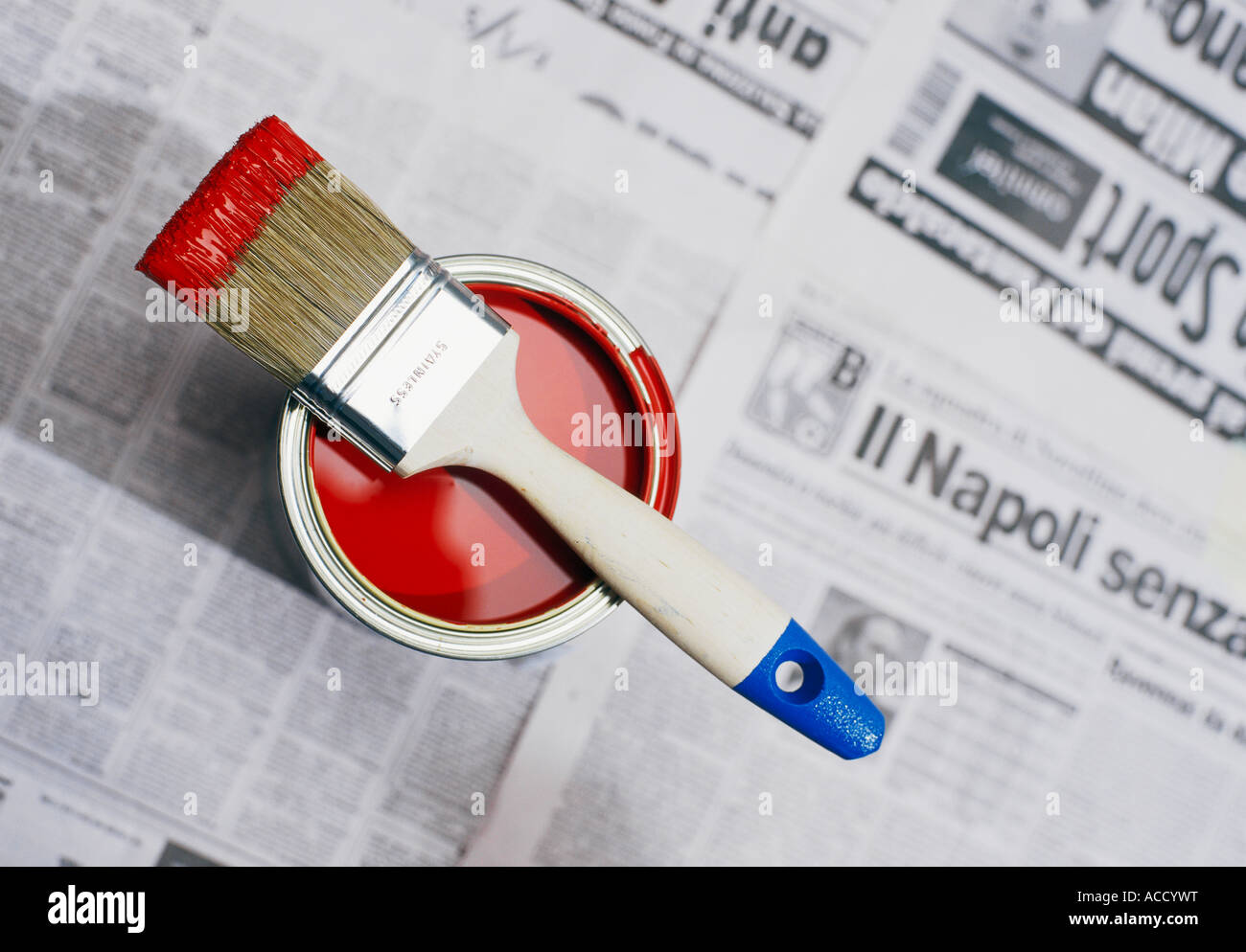 Red paint on a newspaper Stock Photo - Alamy