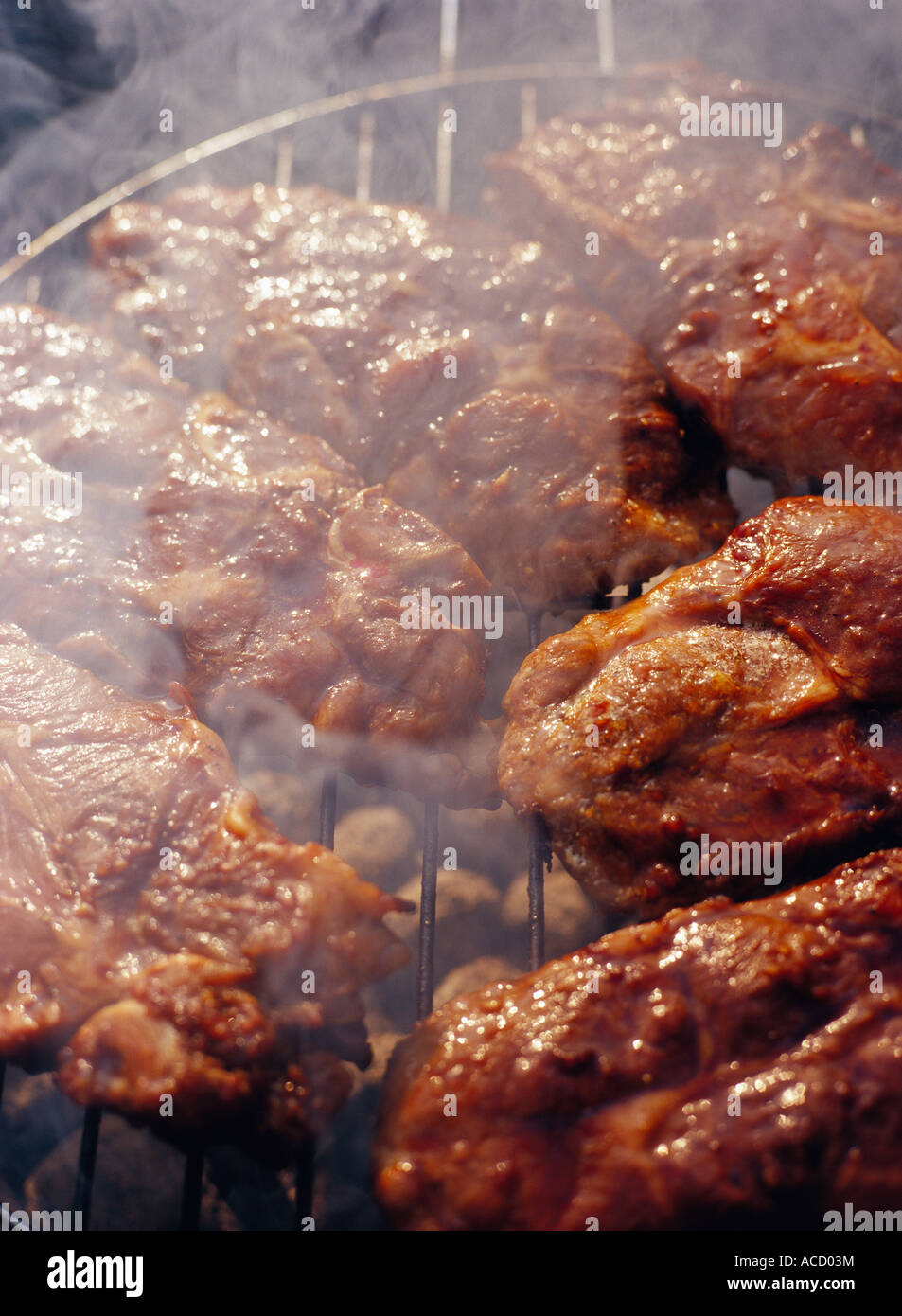 Meat on a grill Stock Photo - Alamy