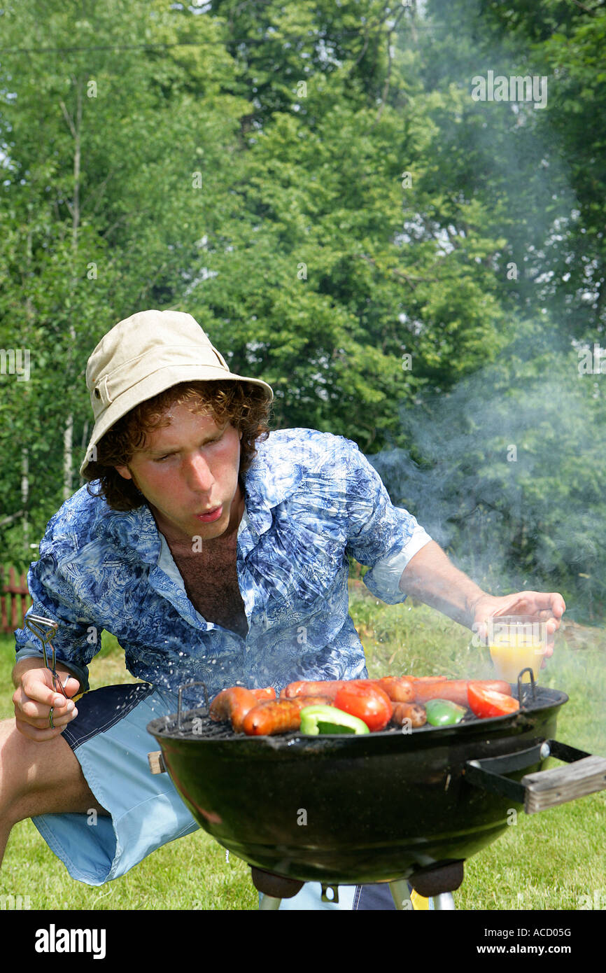 A man barbecuing Stock Photo - Alamy