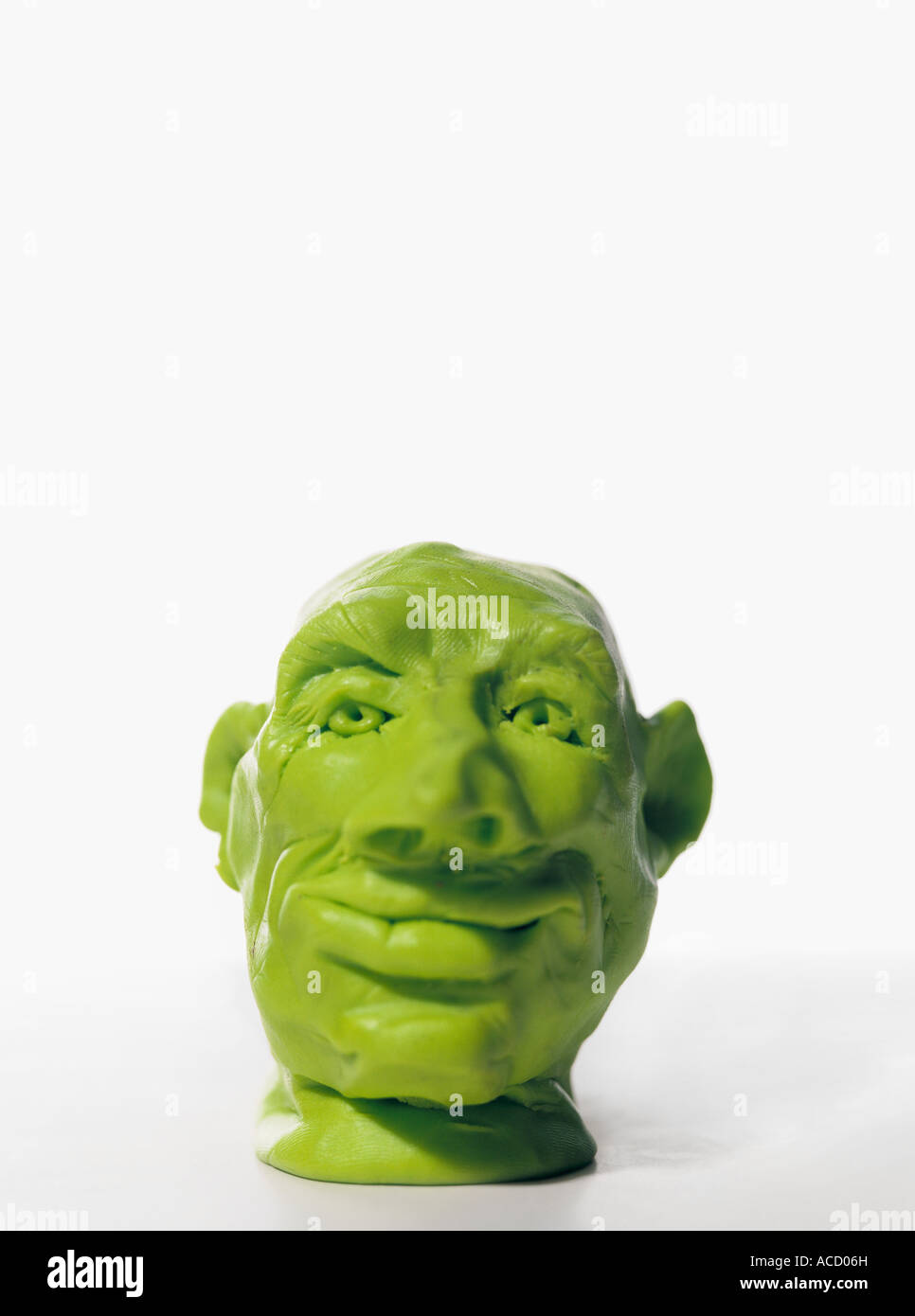 A green head made of clay on a white background close-up Stock Photo ...