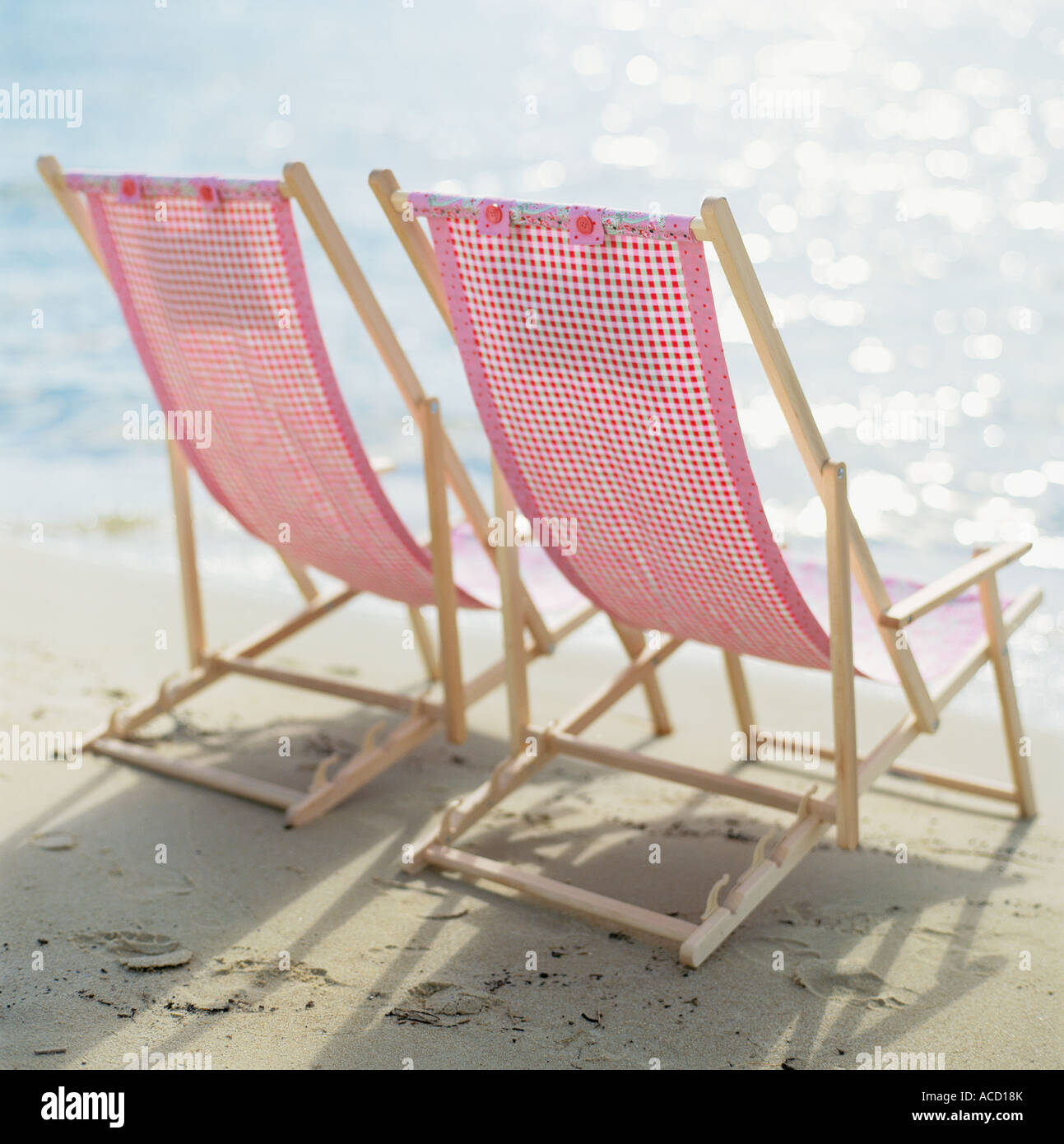 Two sun chairs on a sandy beach Stock Photo - Alamy