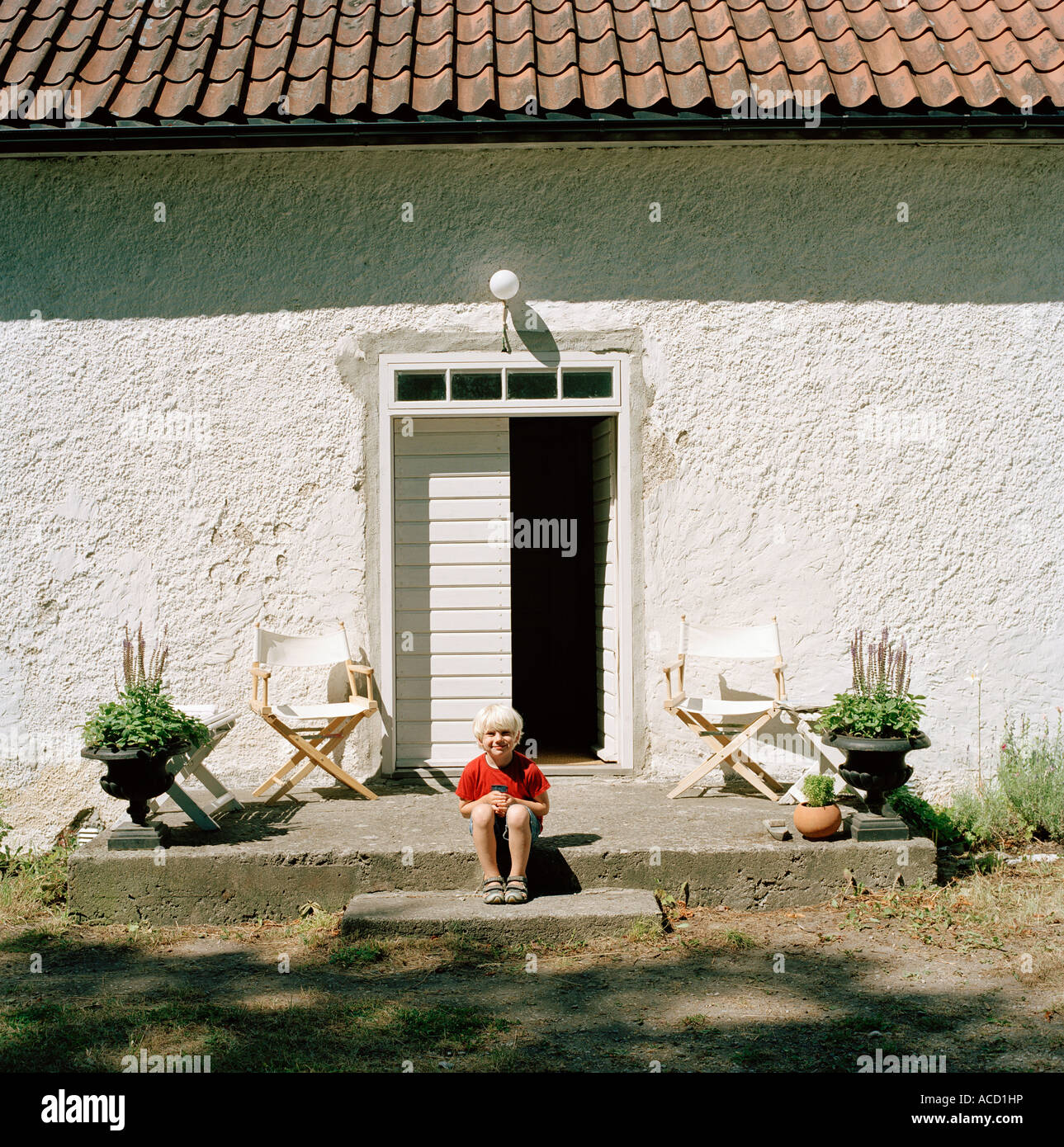 A boy in front of a house Stock Photo - Alamy