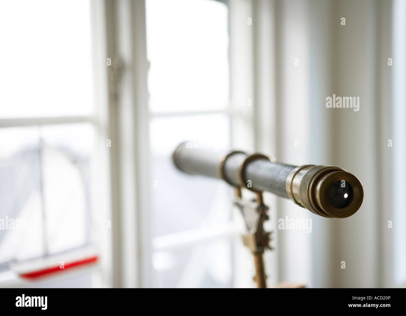 A telescope by a window Stock Photo - Alamy